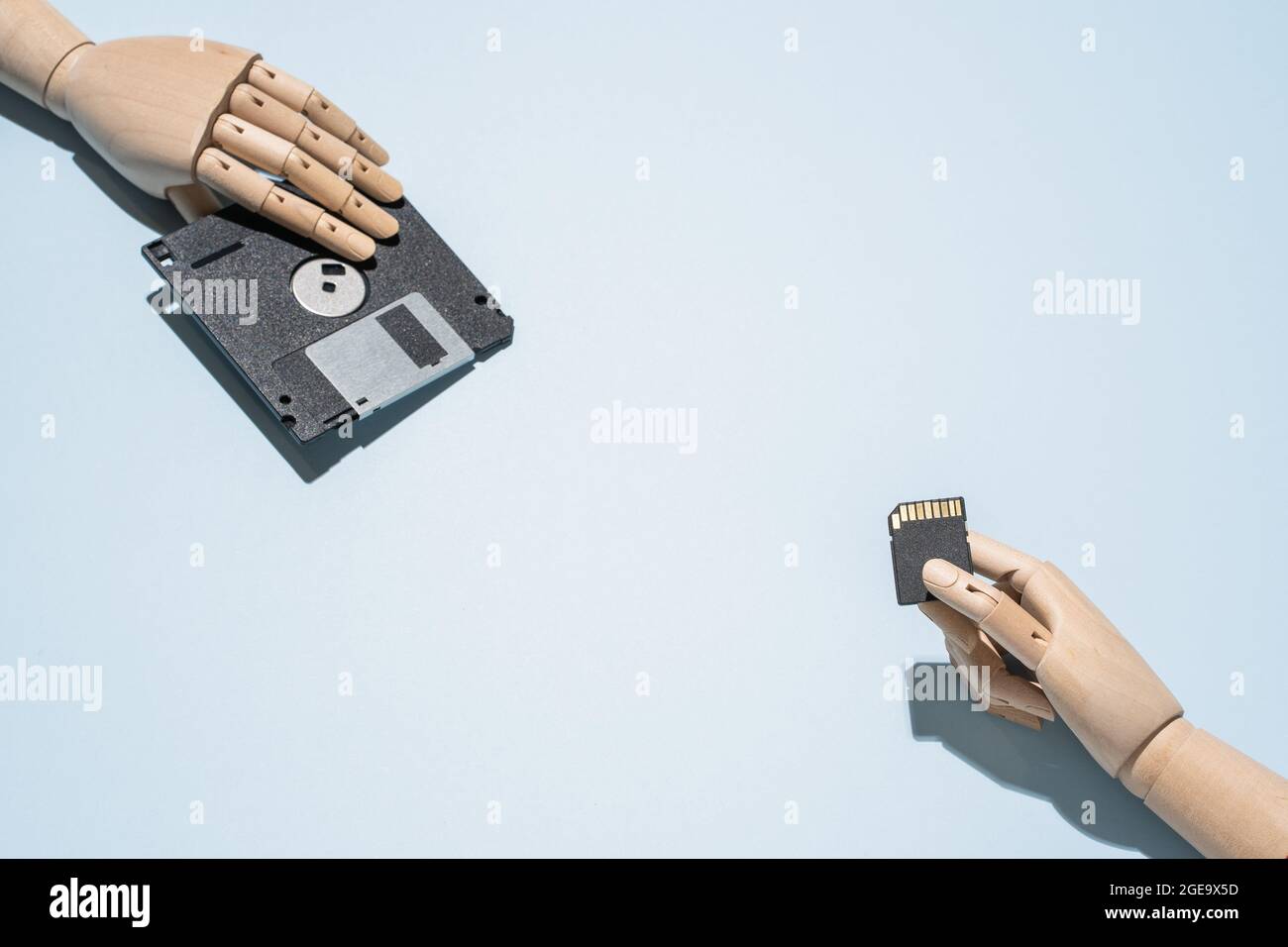 From above of big old fashioned diskette and small contemporary memory ...