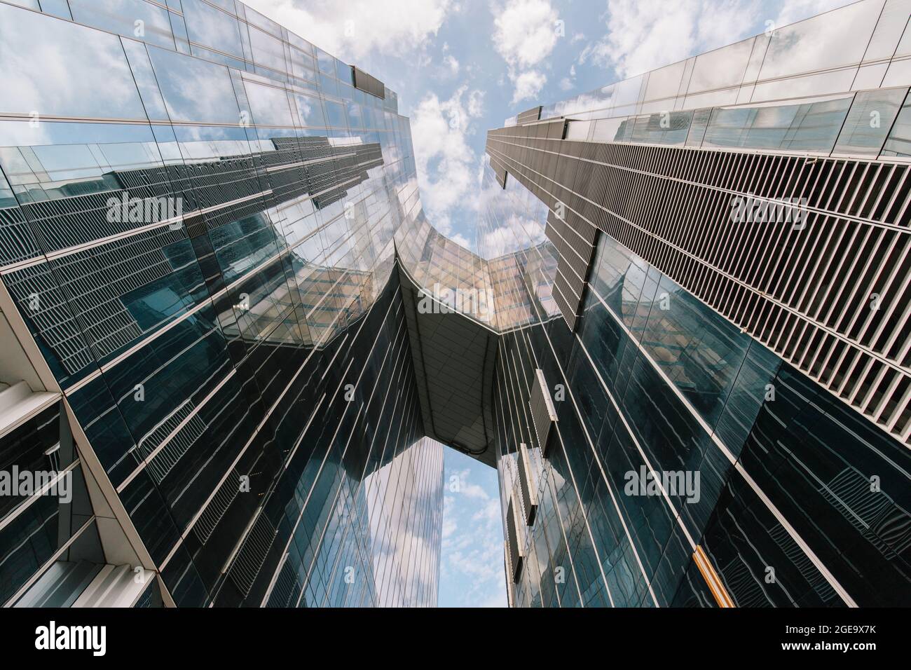 Low angle of contemporary multistory skyscraper with mirrored walls ...