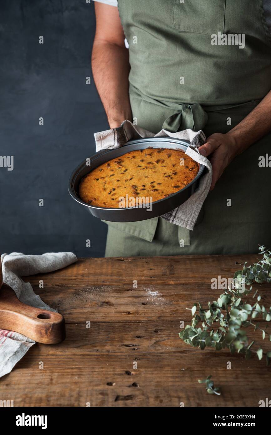 Cropped anonymous male cook holding plate with delicious pumpkin pie on ...