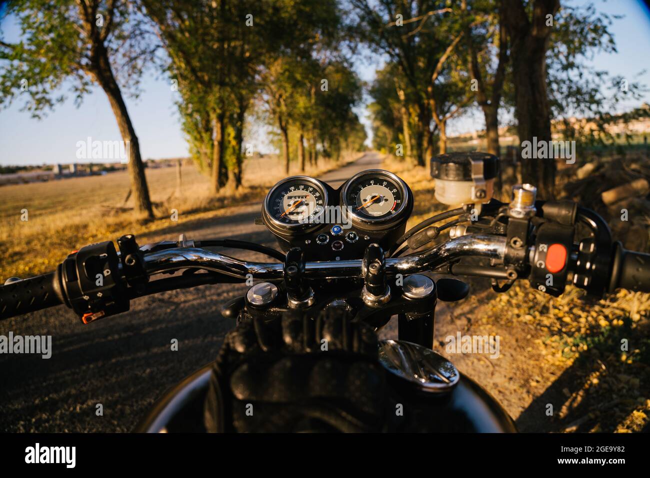Back view of faceless fast racer riding motorbike through forest in ...