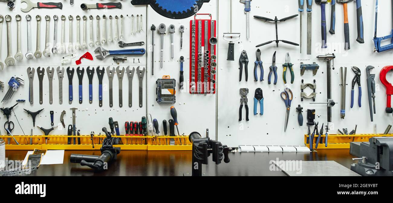 Kit of various professional repair instruments hanging on wall near ...