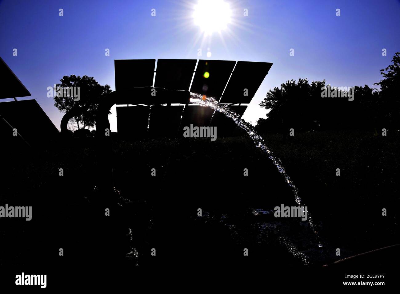 agricultural equipment for field irrigation, water jet, behind which is ...