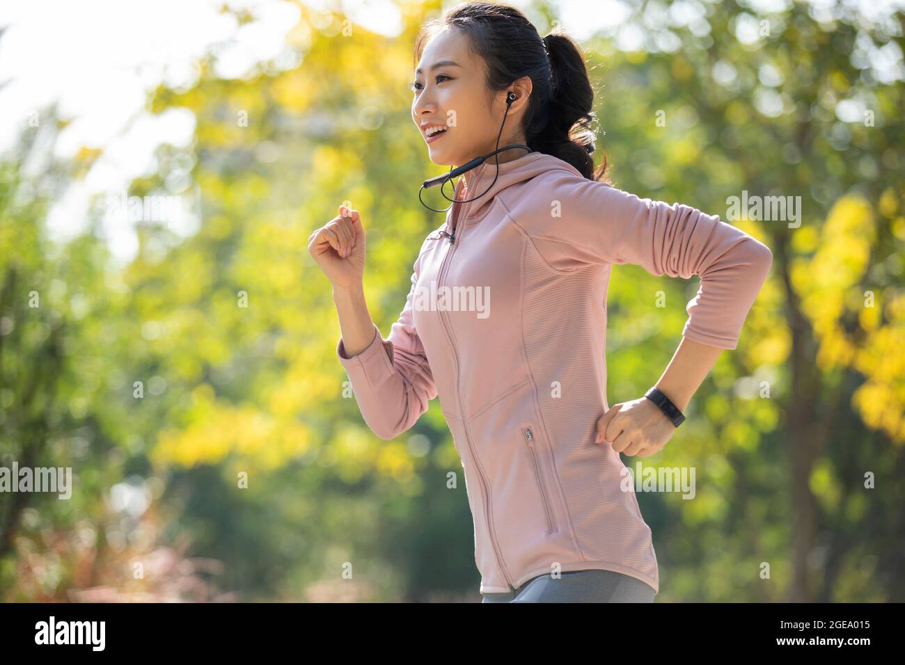 Young Chinese woman jogging in park Stock Photo - Alamy