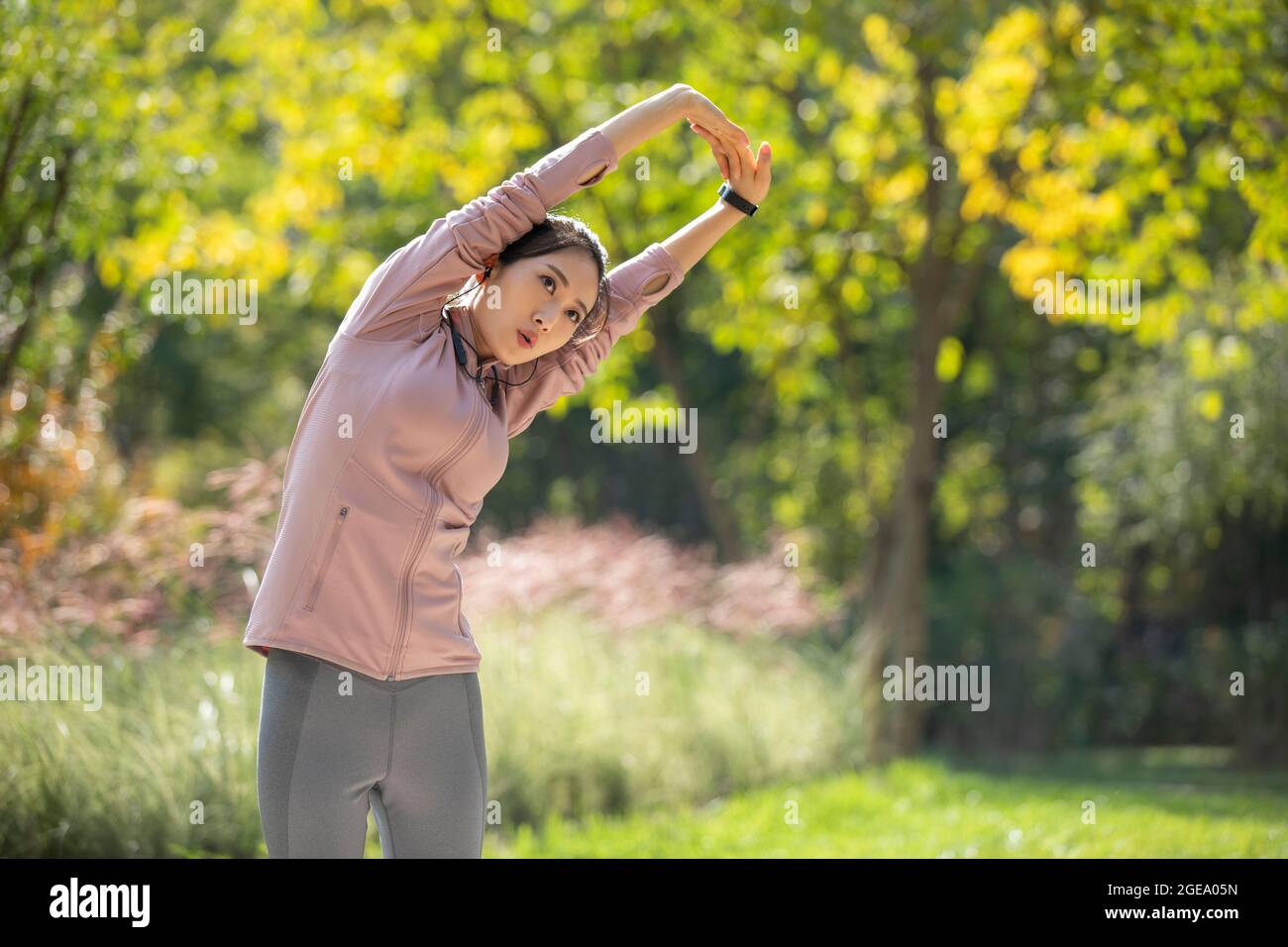 Young Chinese woman exercising in park Stock Photo - Alamy