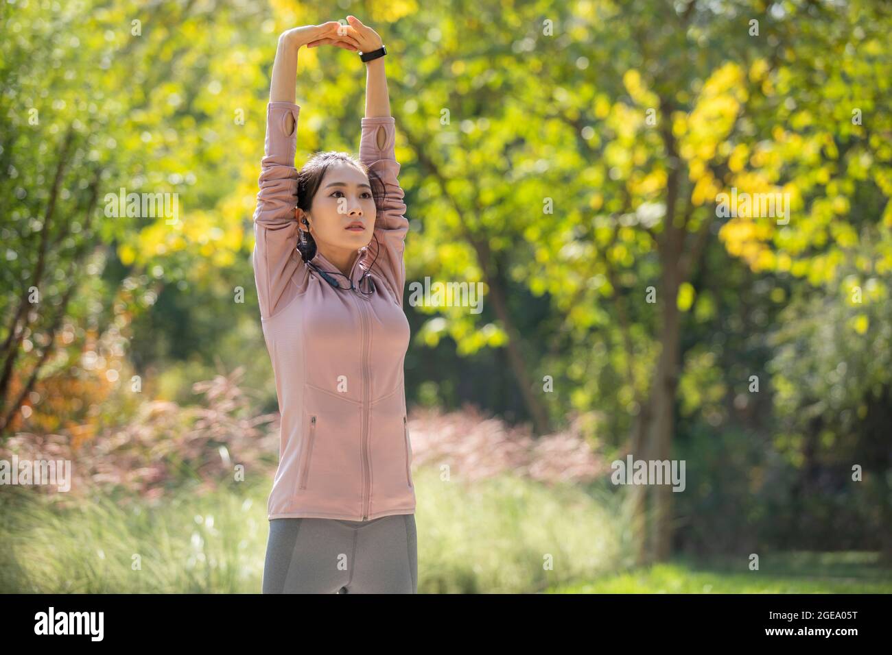 Young Chinese woman exercising in park Stock Photo - Alamy