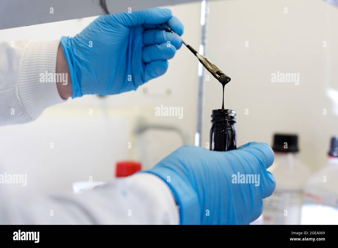 Bio chemistry technician testing material in a fume cupboard Stock ...