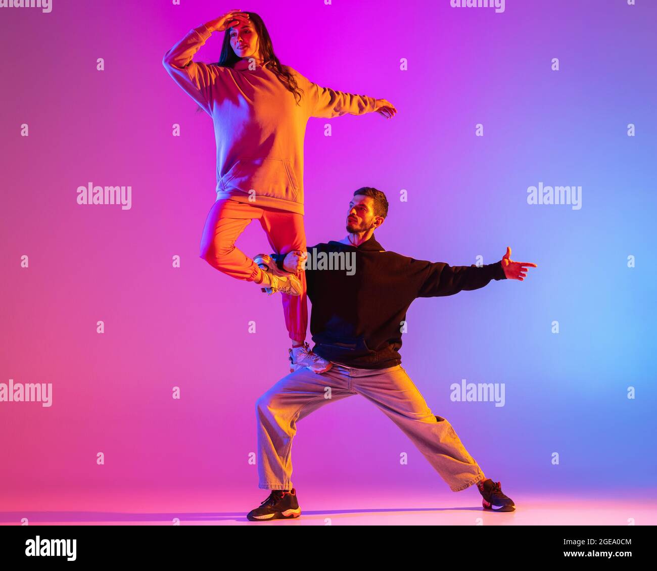 Two young people, guy and girl in casual clothes dancing contemporary ...