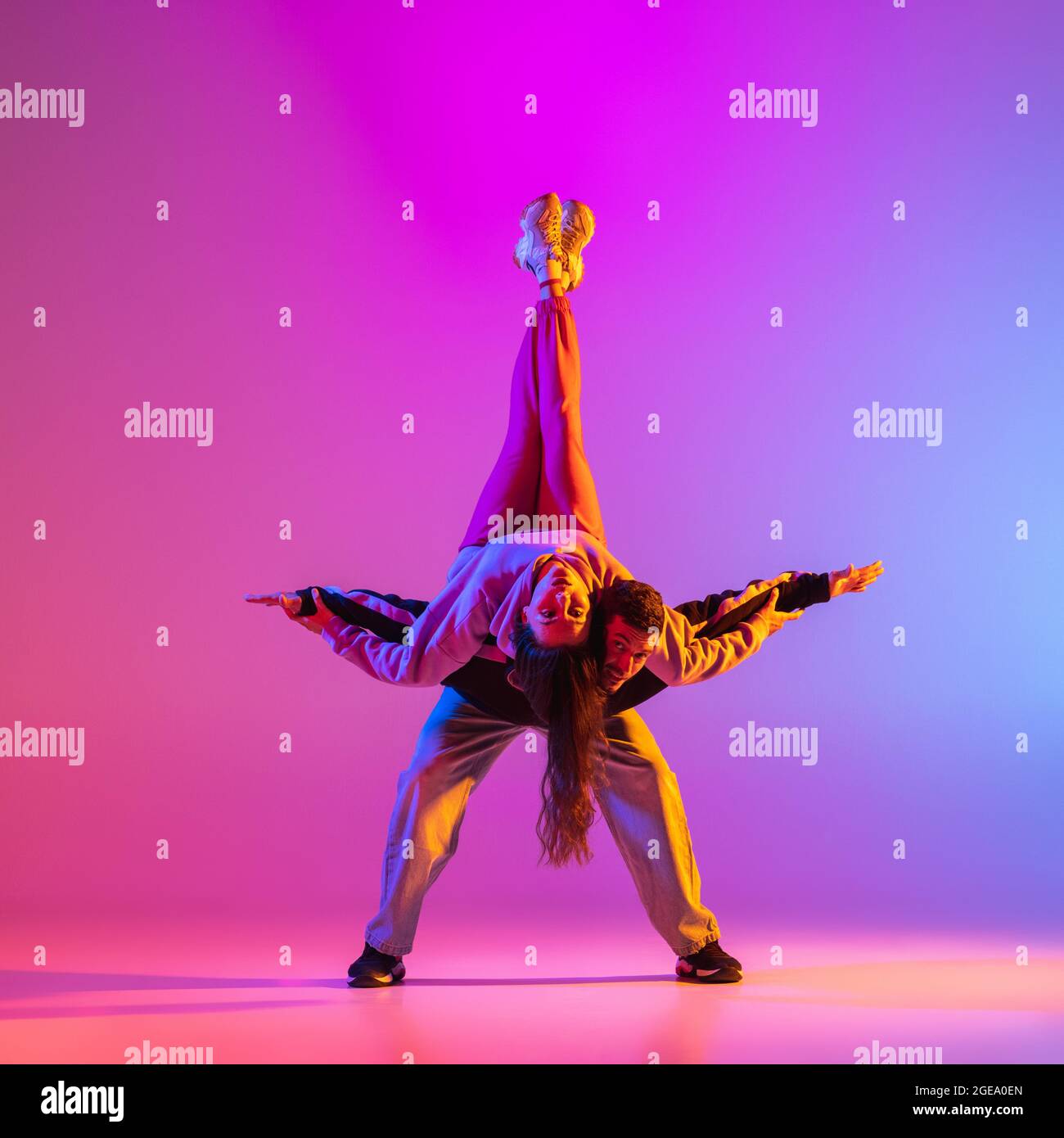 Two young people, guy and girl in casual clothes dancing contemporary ...