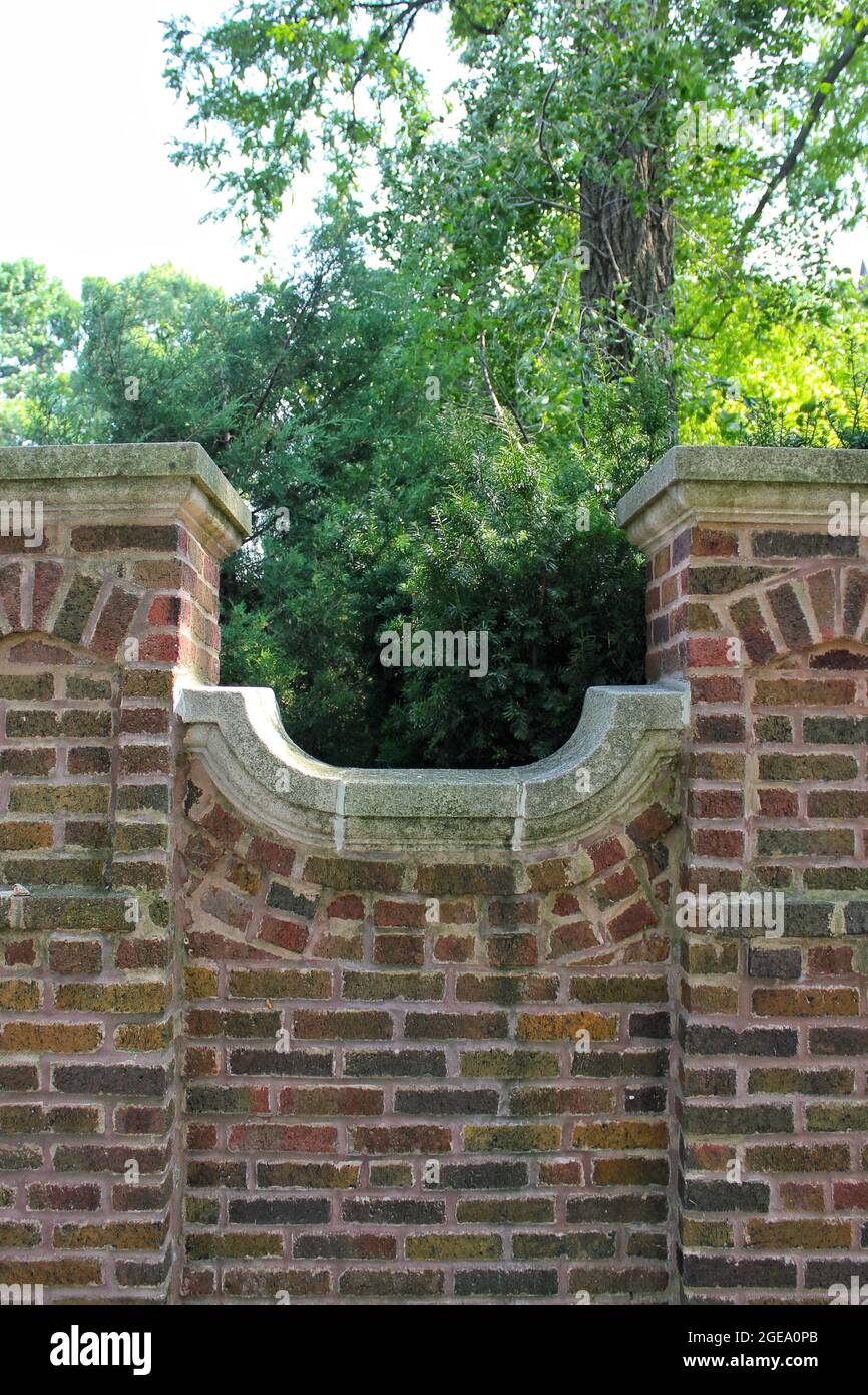 Brick wall with an opening of an old garden Stock Photo - Alamy