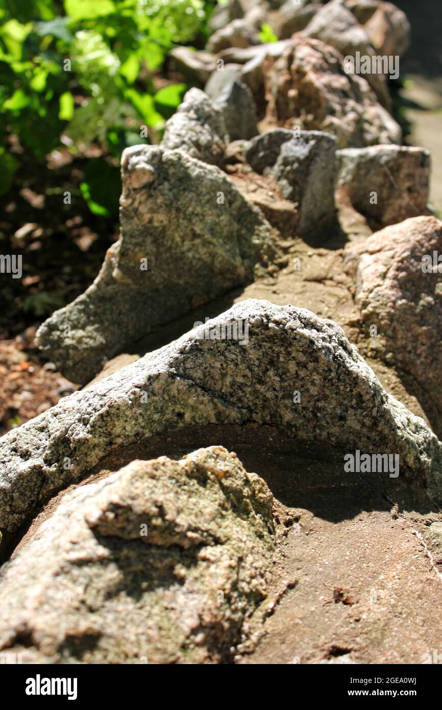 The jagged top of a rustic stone wall Stock Photo - Alamy