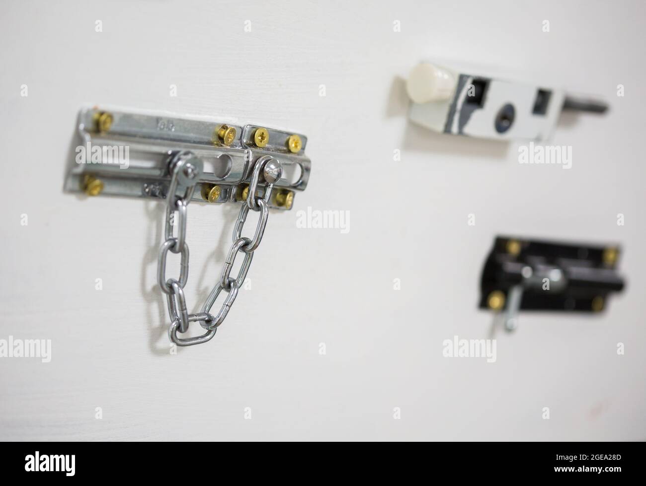 Three household security locks displayed on a white wall Stock Photo ...