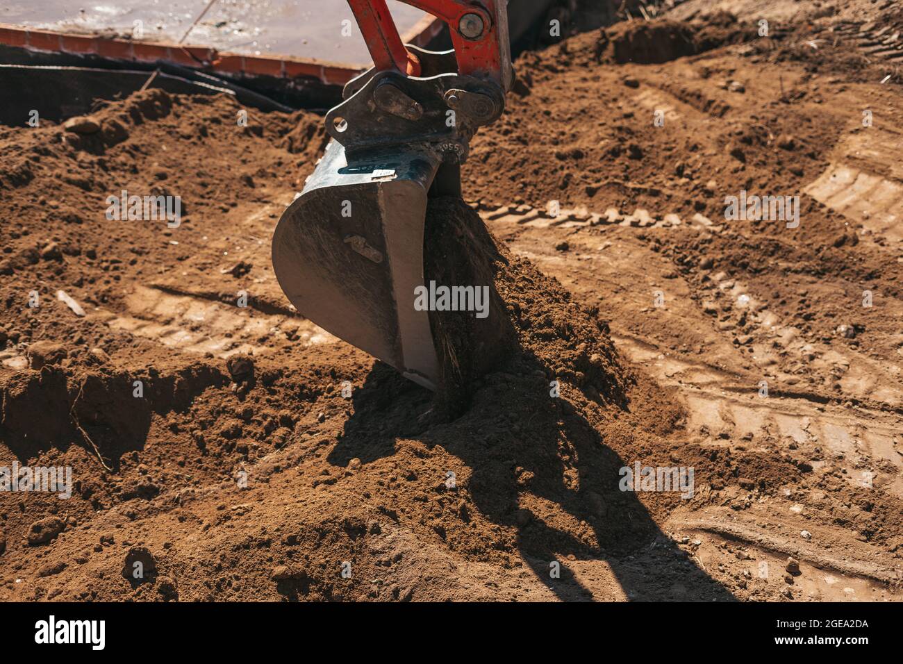 Excavator shovel digging on dirt on a construction site Stock Photo - Alamy