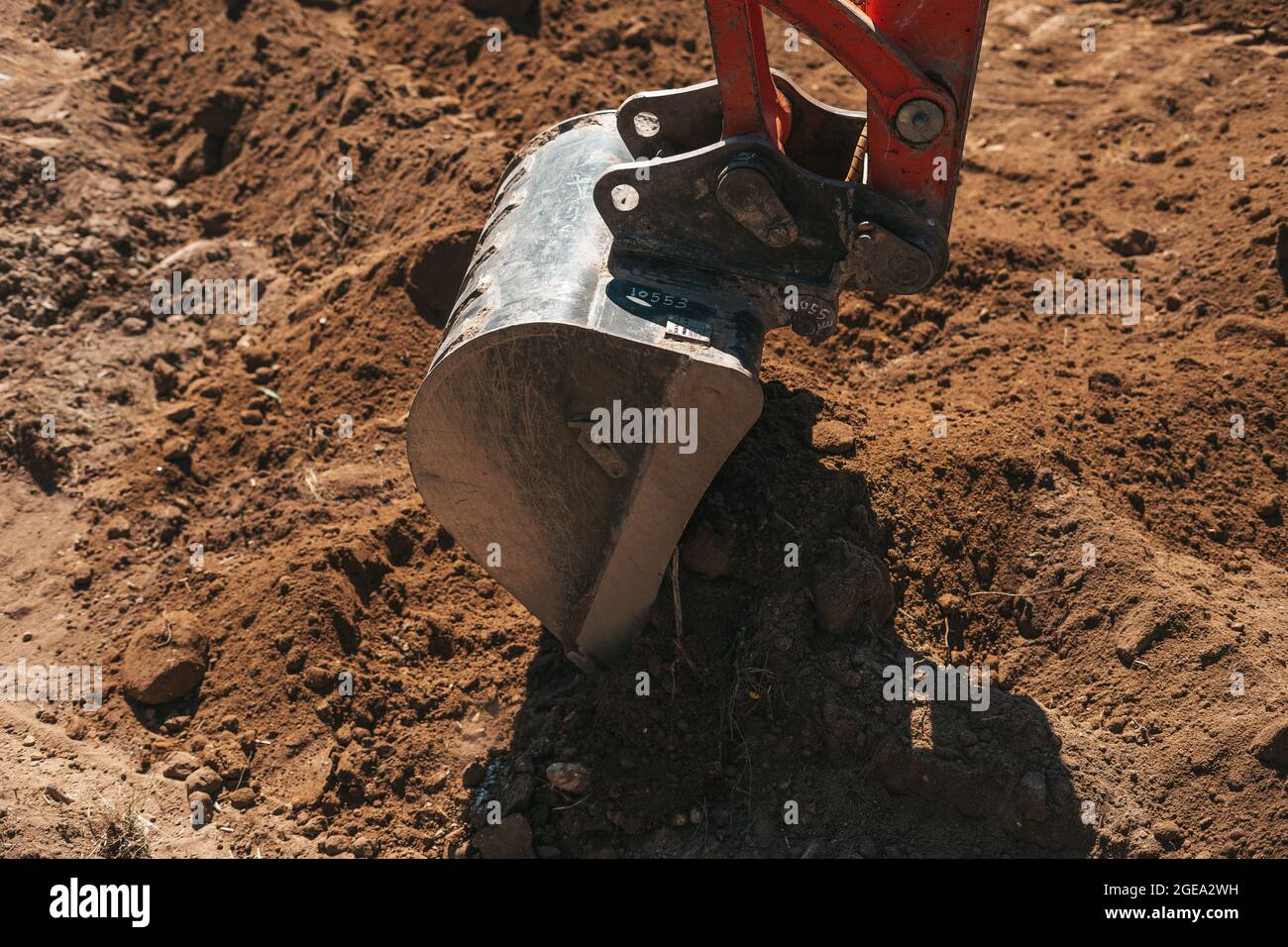 Excavator shovel digging on dirt on a construction site Stock Photo - Alamy
