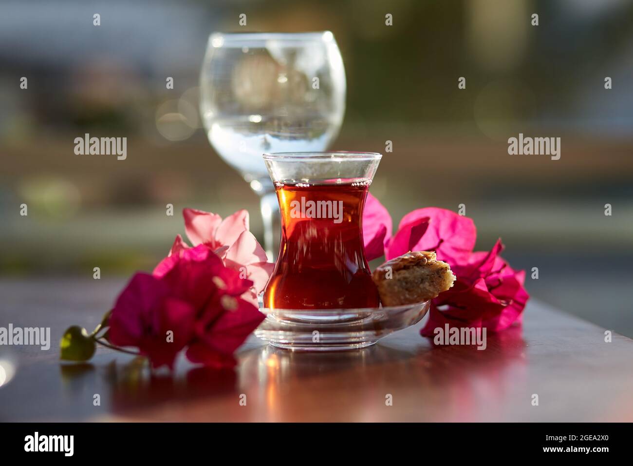 Turkish delight and traditional glass of turkish tea with bougainvillea ...