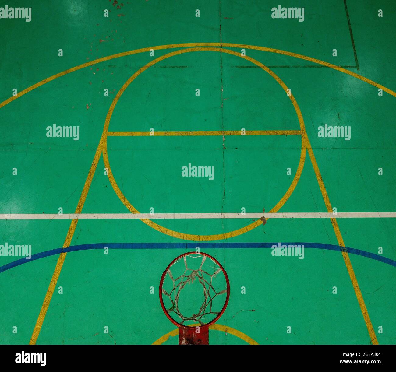 Rusty and weather-spotted basketball hoop seen from above, the green ...