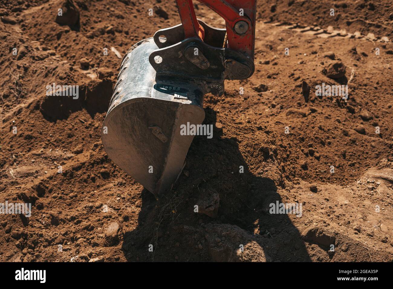 Excavator shovel digging on dirt on a construction site Stock Photo - Alamy