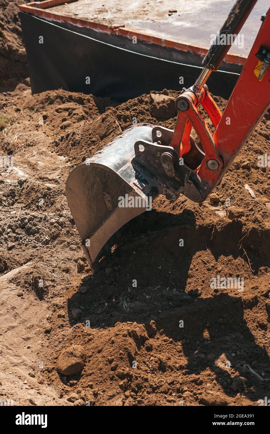 Excavator shovel digging on dirt on a construction site Stock Photo - Alamy