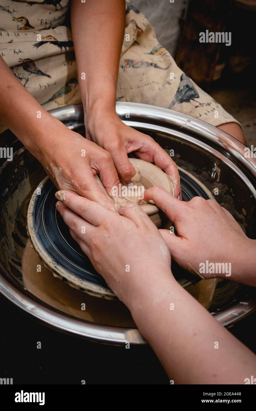 Potter working on potters wheel with clay. Process of making ceramic ...