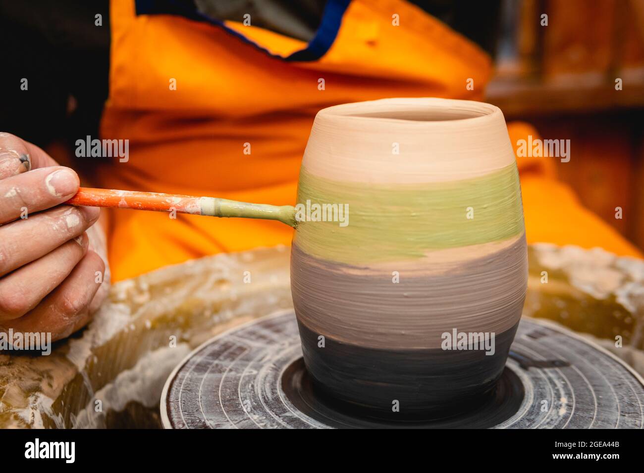 Potter working on potters wheel with clay. Process of making ceramic ...