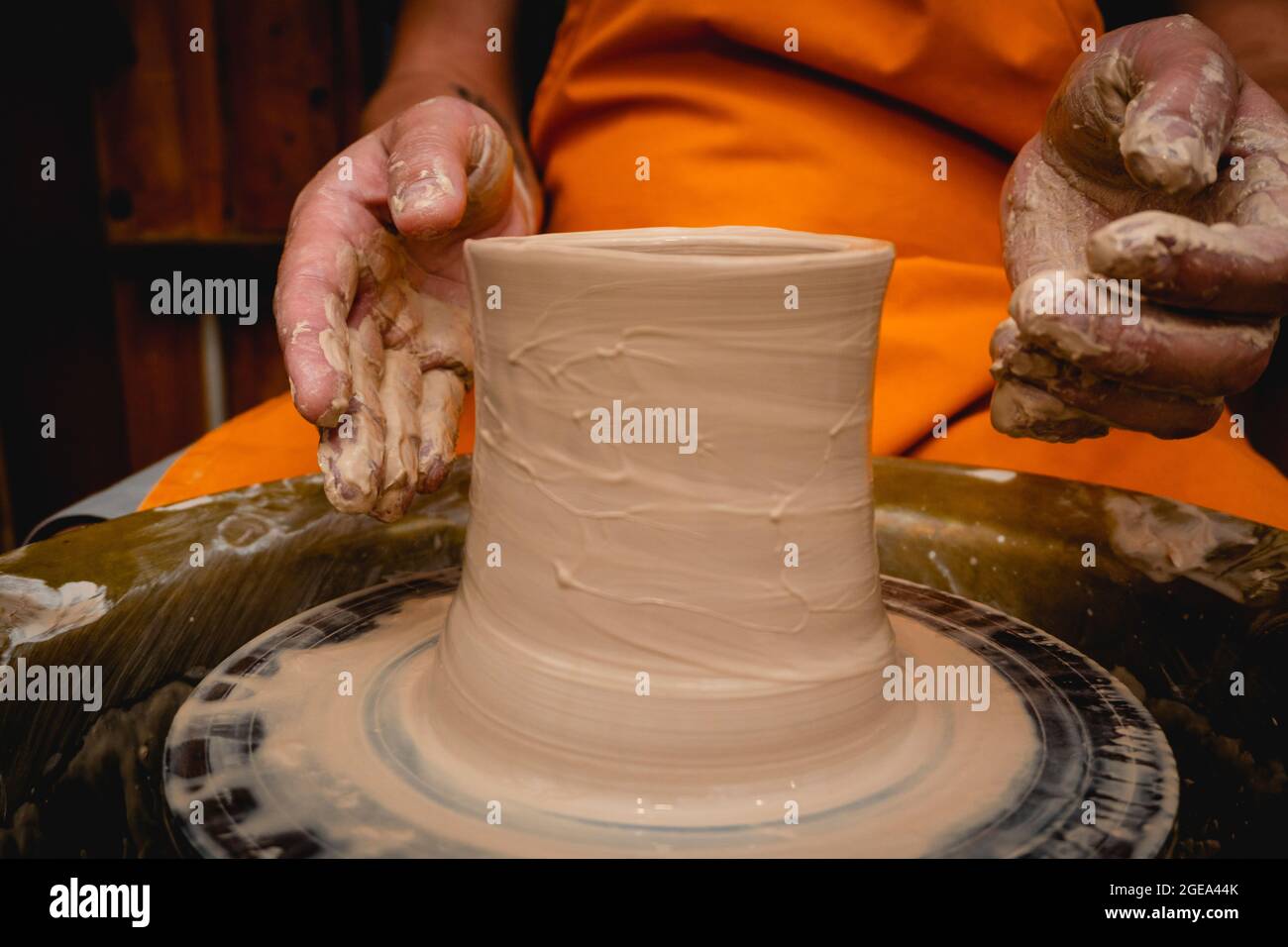 Potter working on potters wheel with clay. Process of making ceramic ...