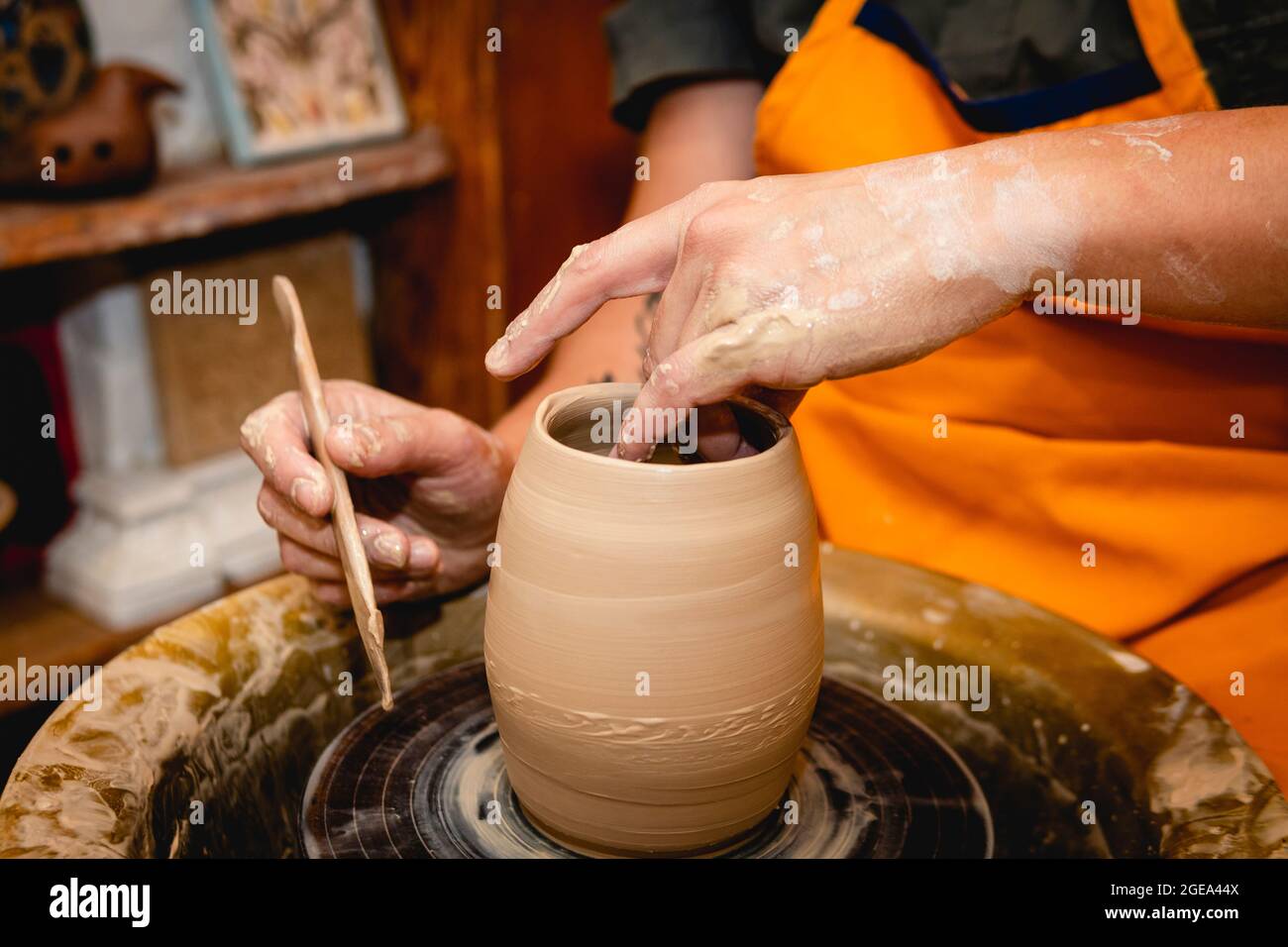 Potter working on potters wheel with clay. Process of making ceramic ...