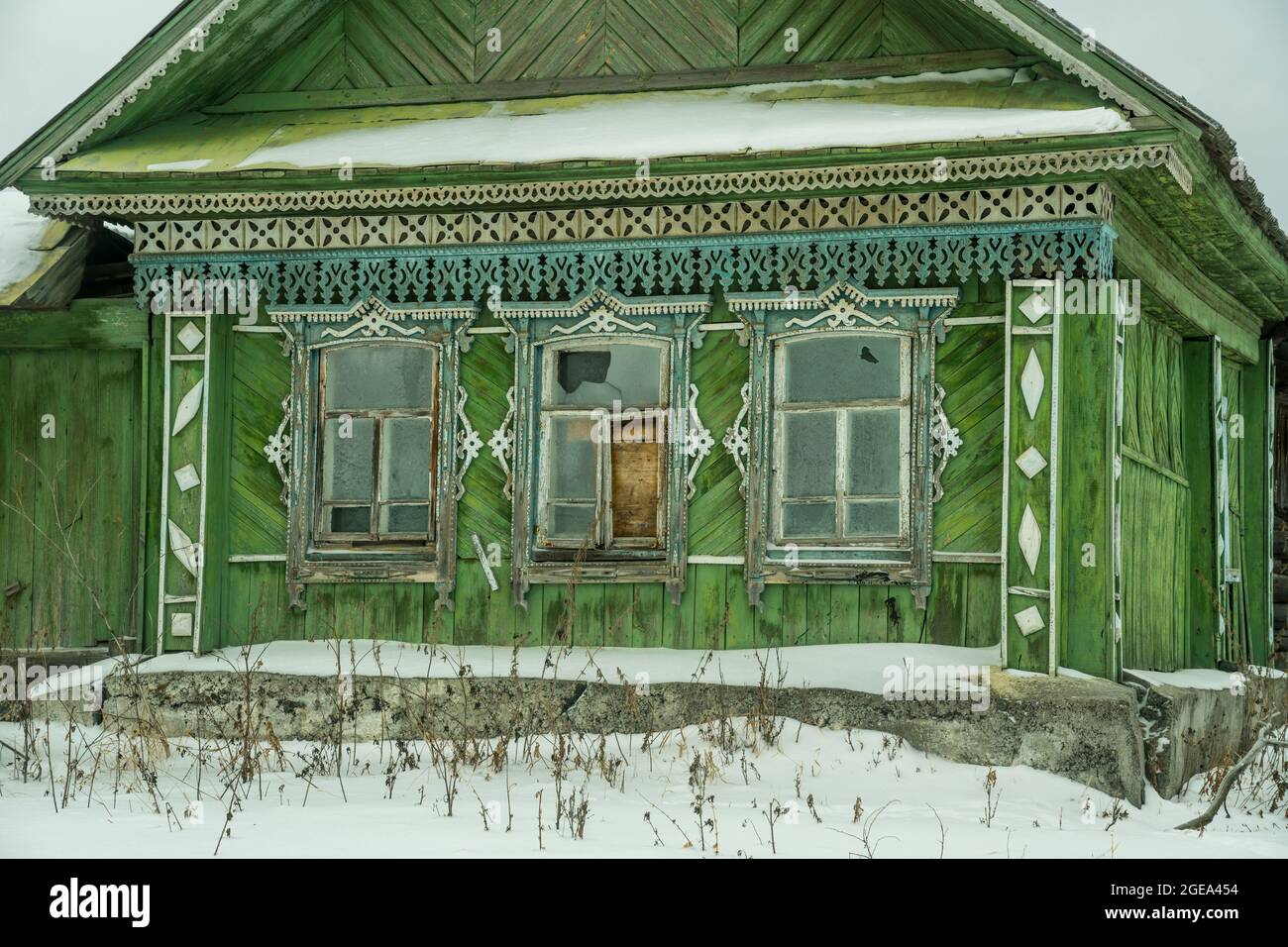 A traditional Russian cottage blanketed with snow in a village in the ...