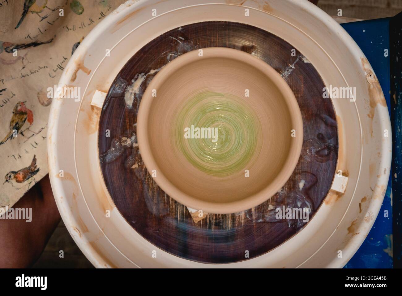 Potter working on potters wheel with clay. Process of making ceramic ...