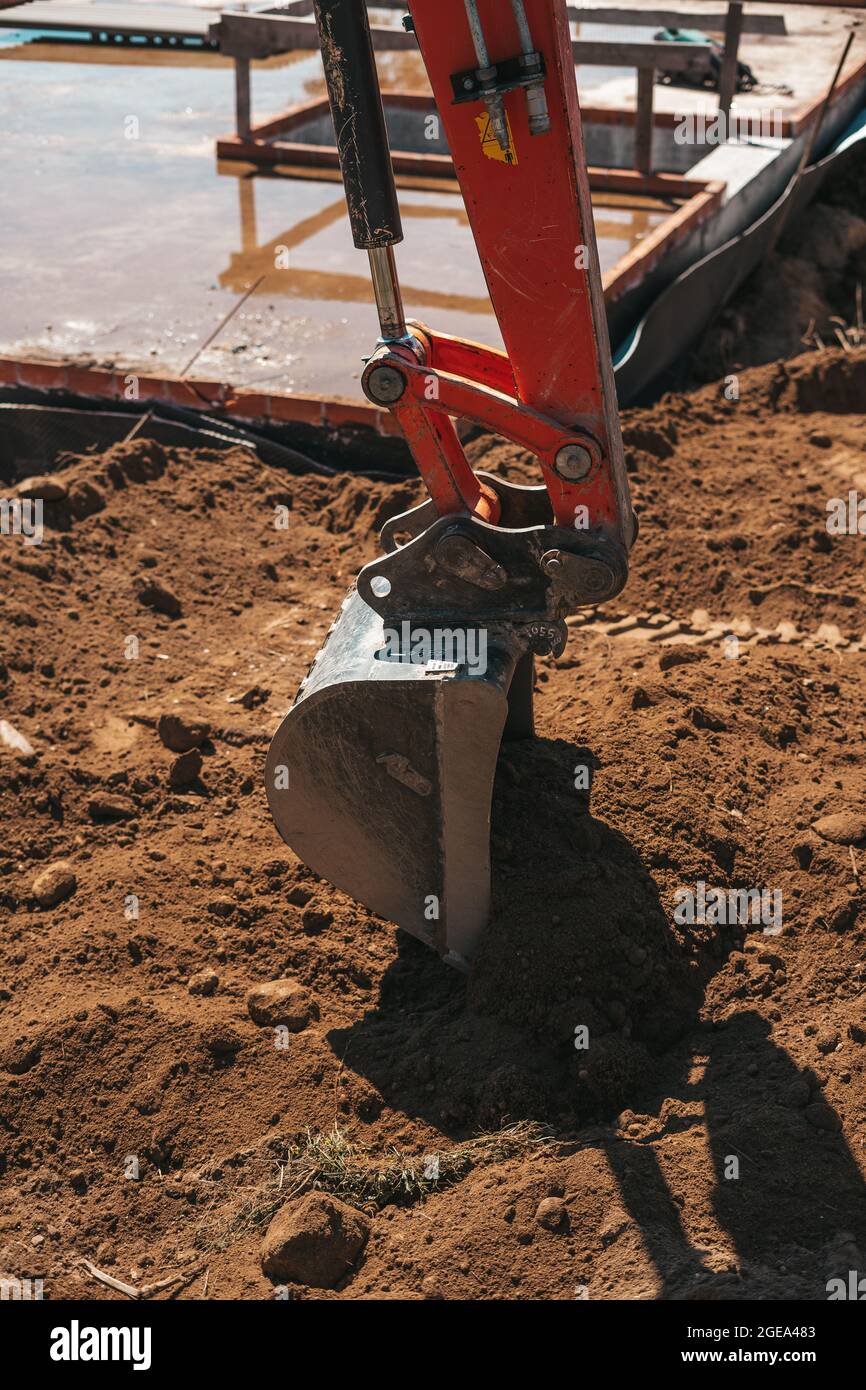 Excavator shovel digging on dirt on a construction site Stock Photo - Alamy