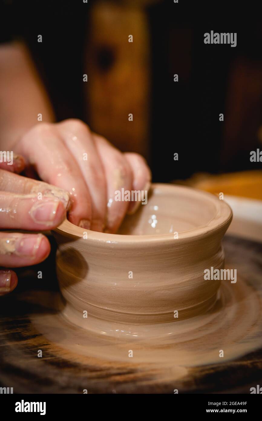 Potter working on potters wheel with clay. Process of making ceramic ...