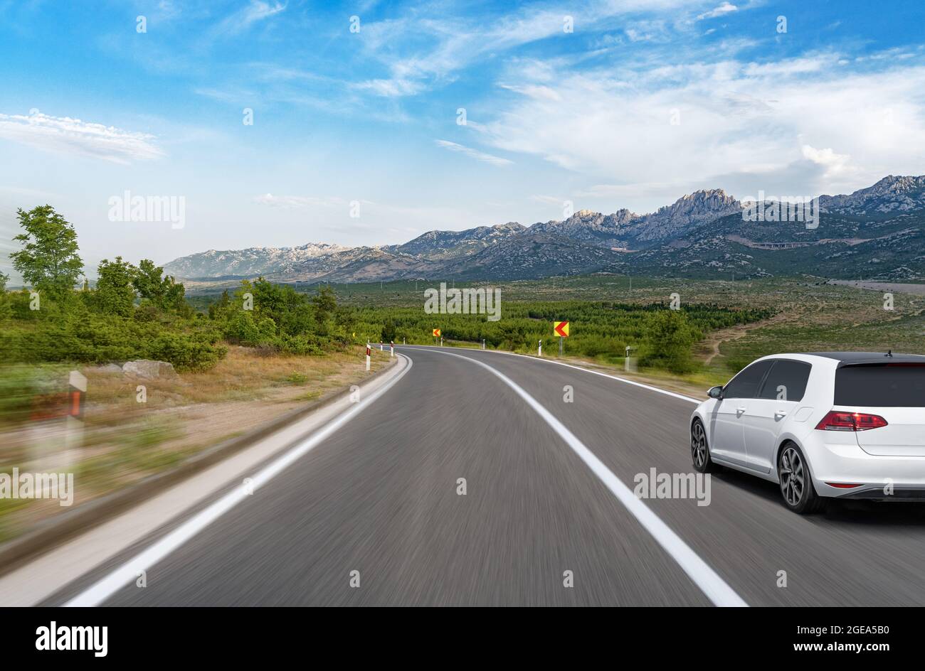 Car is driving along the road. White car on a suburban highway Stock ...