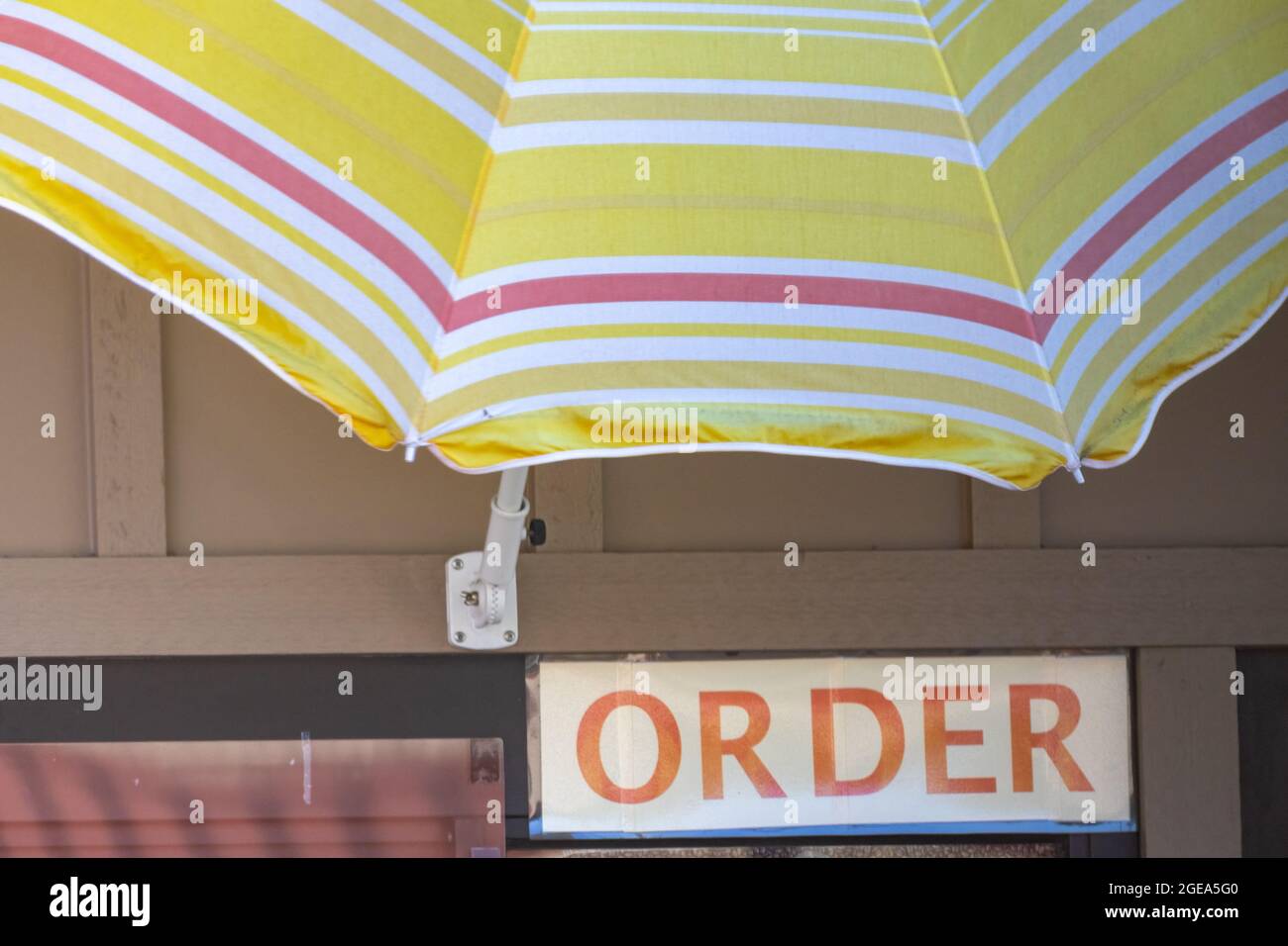 window labeled order under yellow umbrella Stock Photo - Alamy