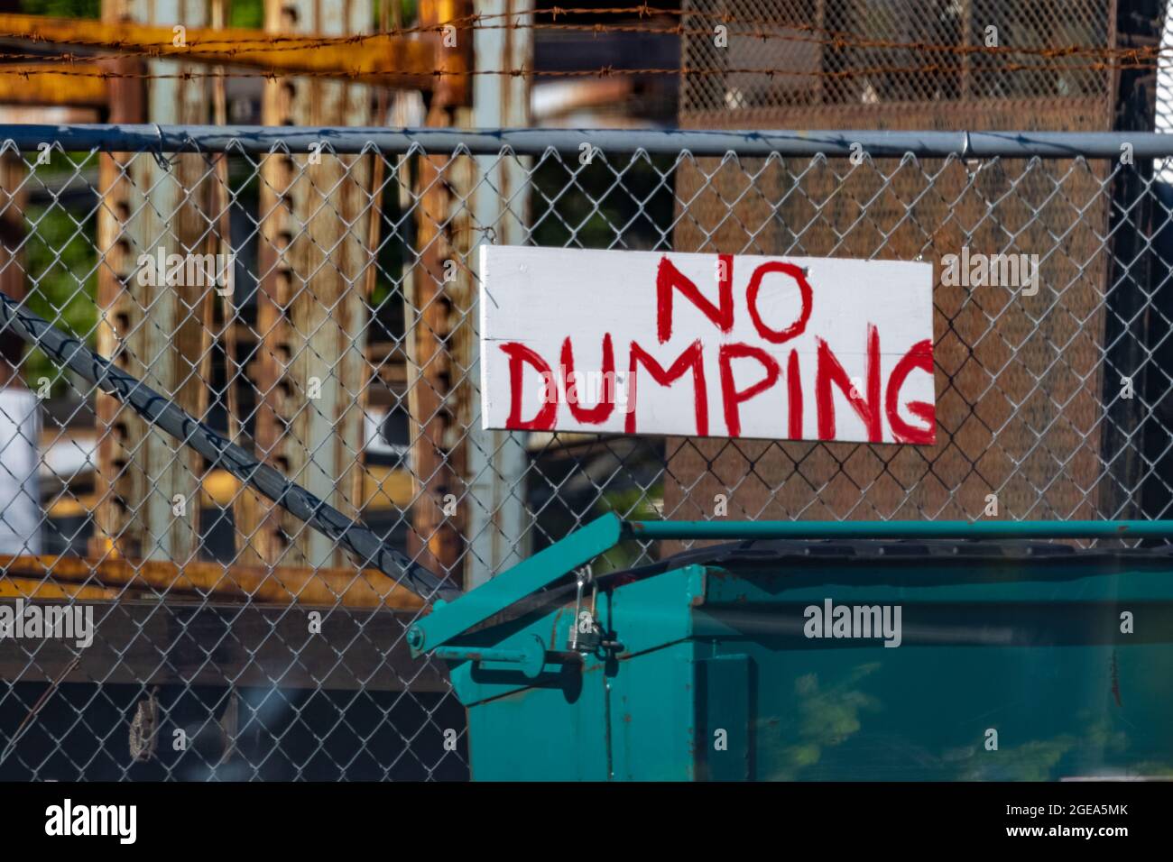 red painted no dumping sign over dumpster Stock Photo - Alamy