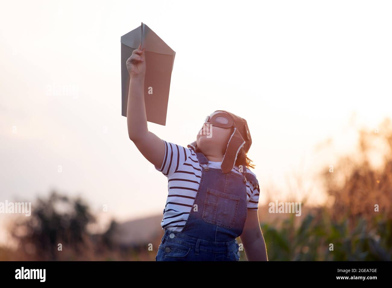 Happy kid playing in pilot helmet pretend to be aviator. Travel ...
