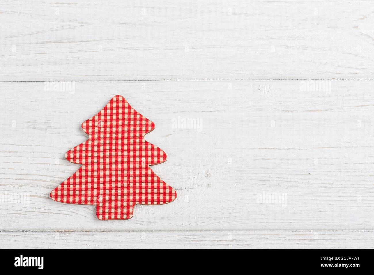 Red decorative fir tree on rustic white wooden table. Christmas ...