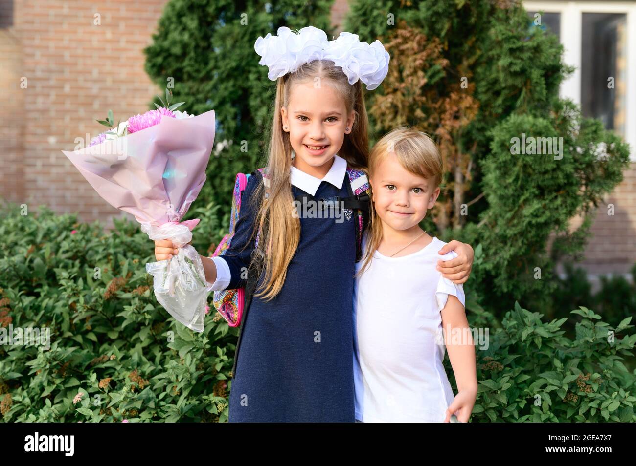 portrait of a cute little seven year old first-grader girl with a ...