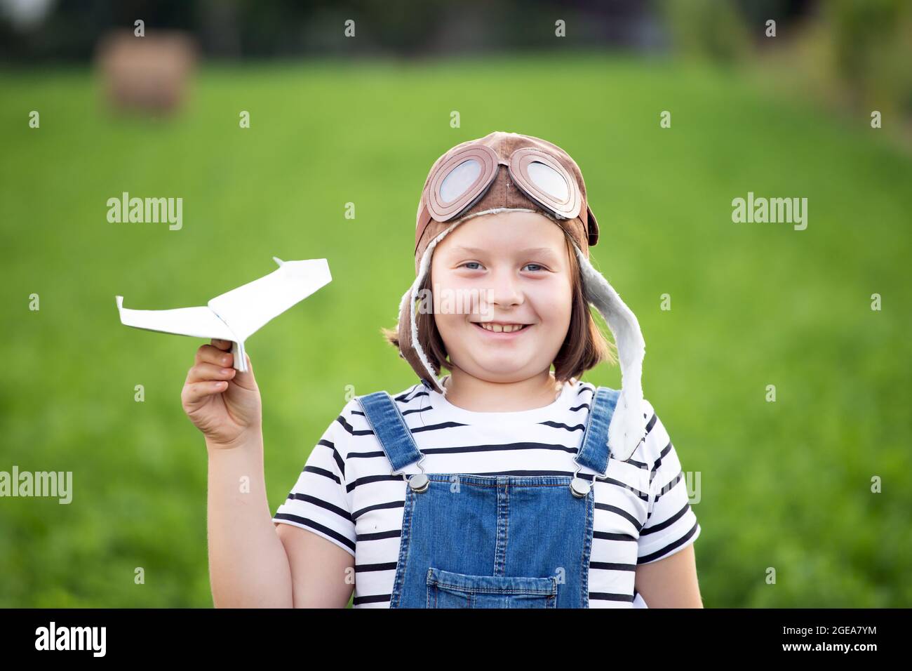 Happy kid playing in pilot helmet pretend to be aviator. Travel ...