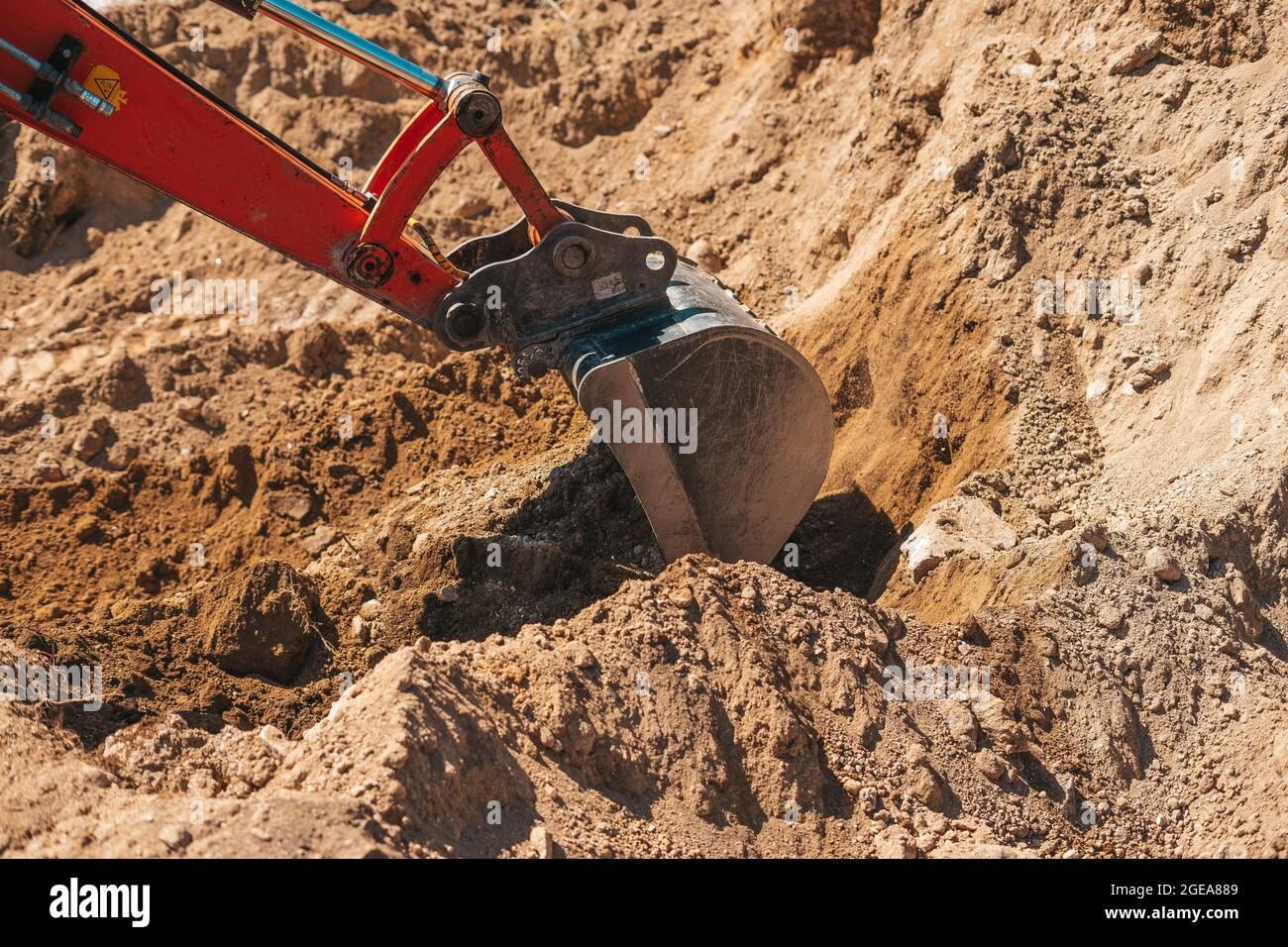 Excavator shovel digging on dirt on a construction site Stock Photo - Alamy