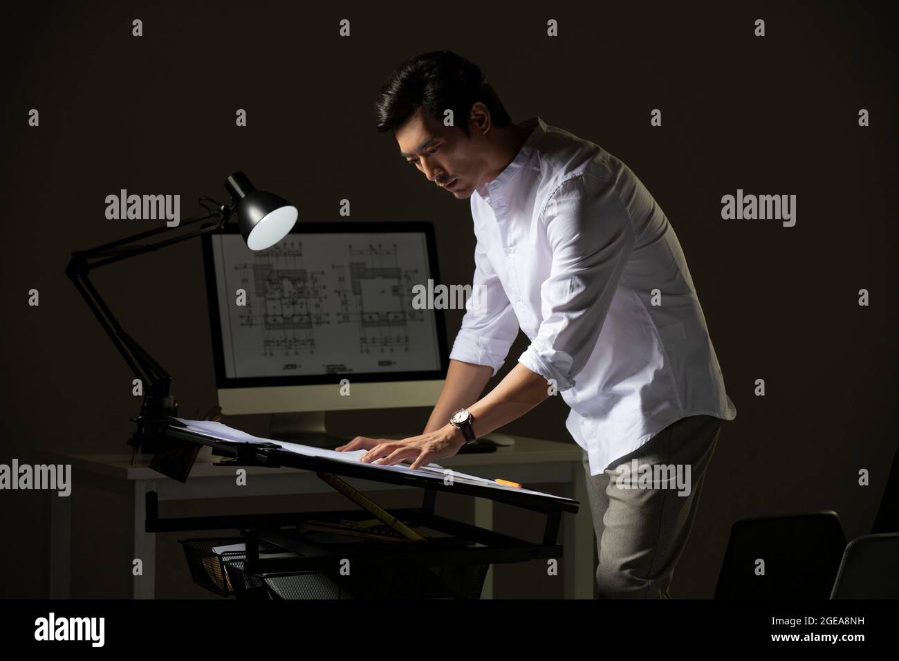 Chinese designer working on construction plan Stock Photo - Alamy