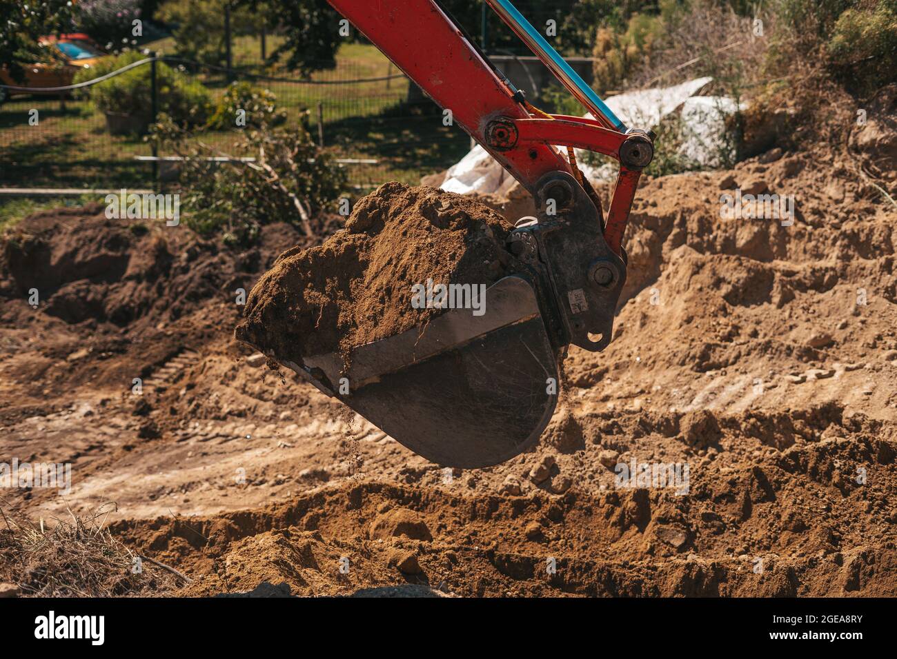 Excavator shovel digging on dirt on a construction site Stock Photo - Alamy