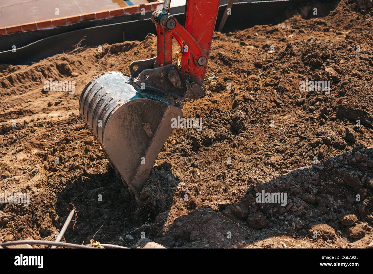 Excavator shovel digging on dirt on a construction site Stock Photo - Alamy