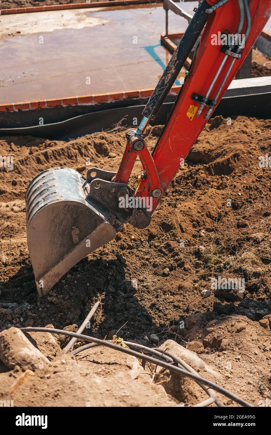 Excavator shovel digging on dirt on a construction site Stock Photo - Alamy