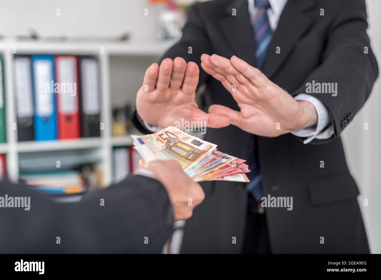 Businessman refusing to take bribe Stock Photo - Alamy
