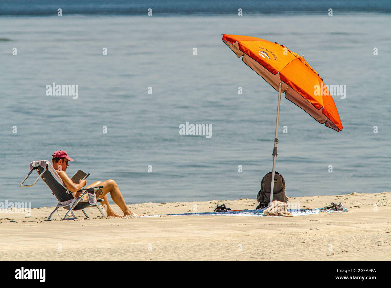 A man is relaxing in a beach chair on a Cape Cod beach Stock Photo - Alamy