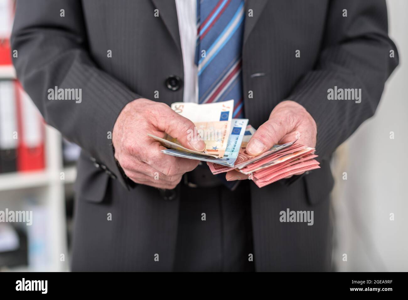 Businessman counting his money at office Stock Photo - Alamy