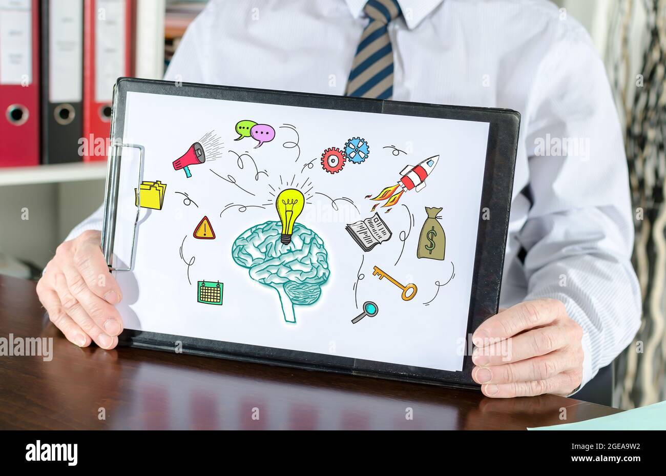 Business idea concept shown by a businessman Stock Photo - Alamy