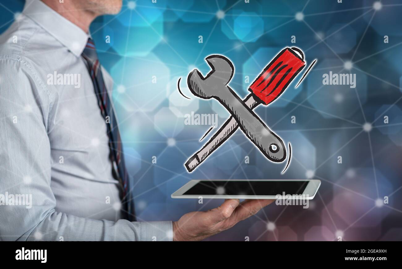 Maintenance service concept above a tablet held by a man Stock Photo ...