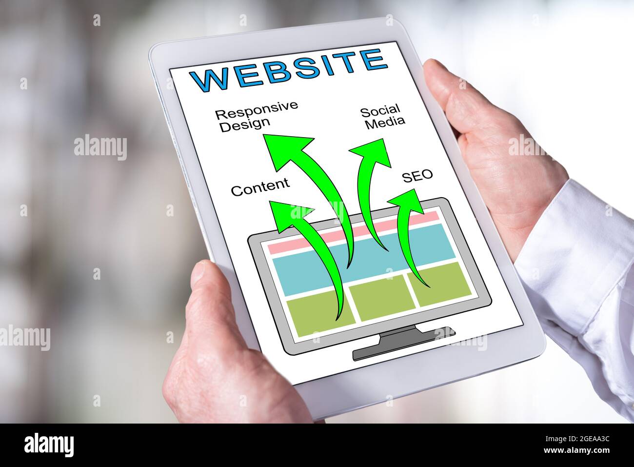 Man holding a tablet showing website concept Stock Photo - Alamy