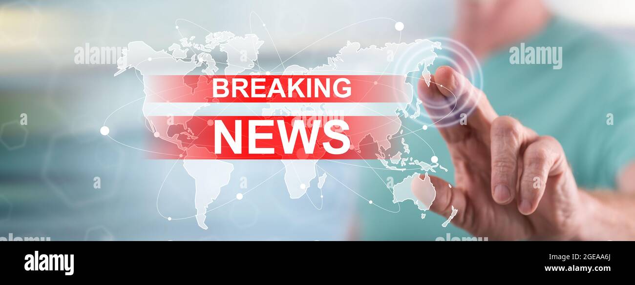 Man touching a breaking news concept on a touch screen with his finger ...