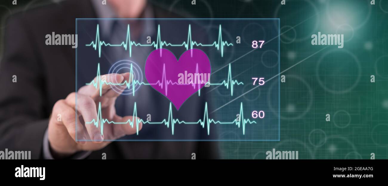 Man touching a heart beats graph concept on a touch screen with his ...