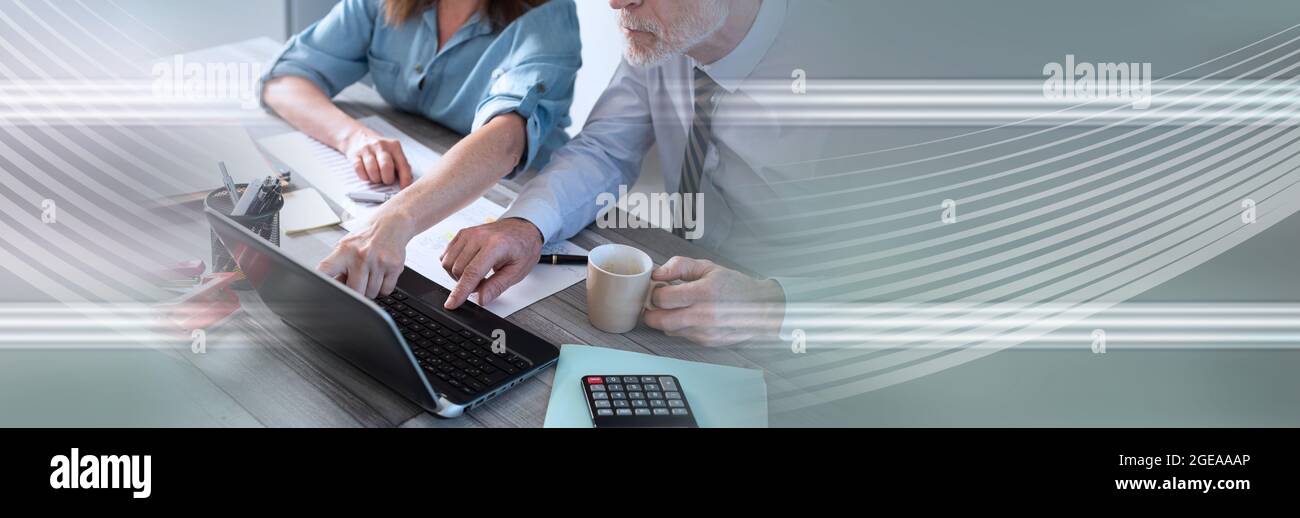 Two mature business people working together in office. panoramic banner ...